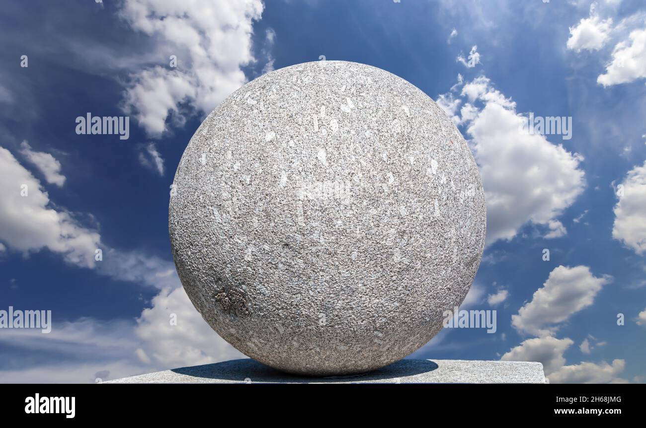 Large granite ball on the background of the sky with clouds Stock Photo ...
