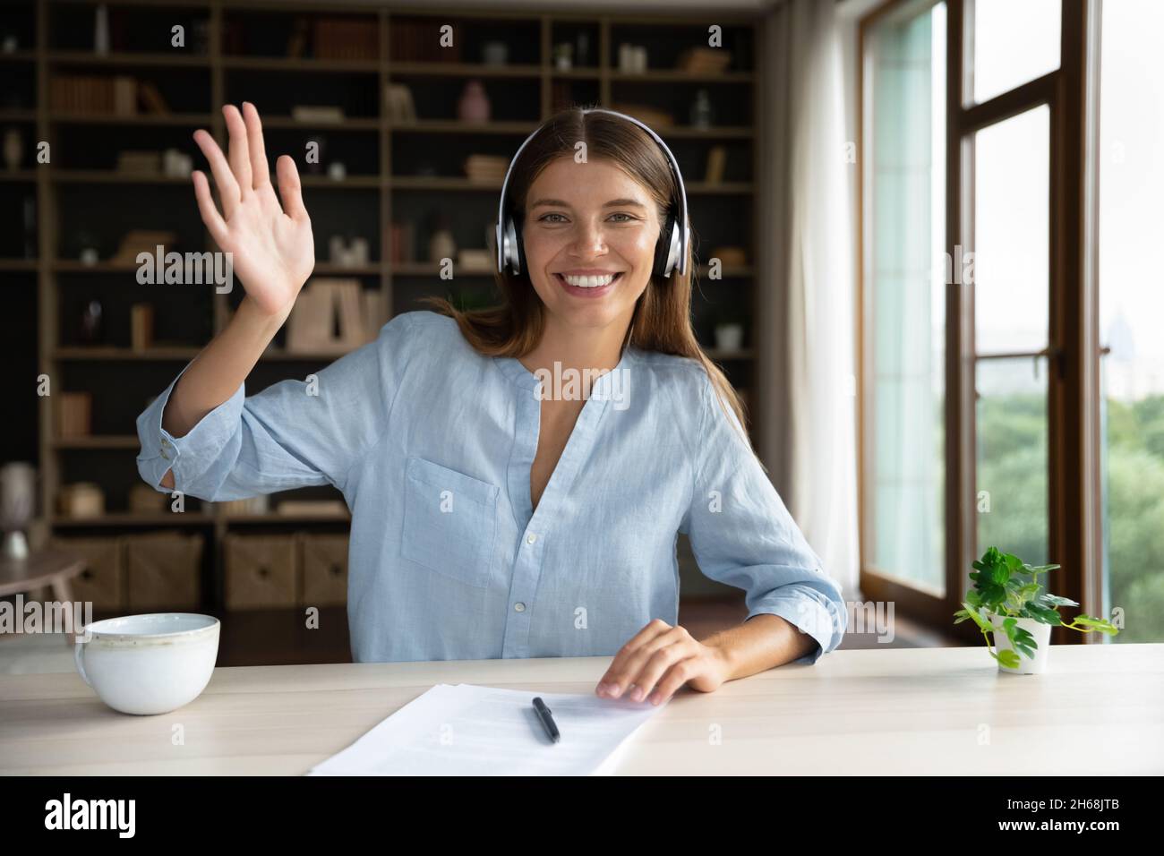 Smiling attractive young woman starting video call Stock Photo - Alamy