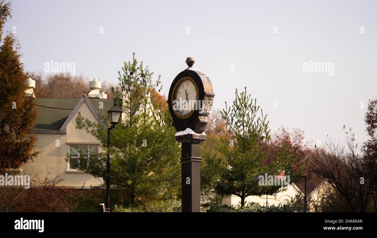 a turret clock in the park looks like a beautiful town in the fall. a ...