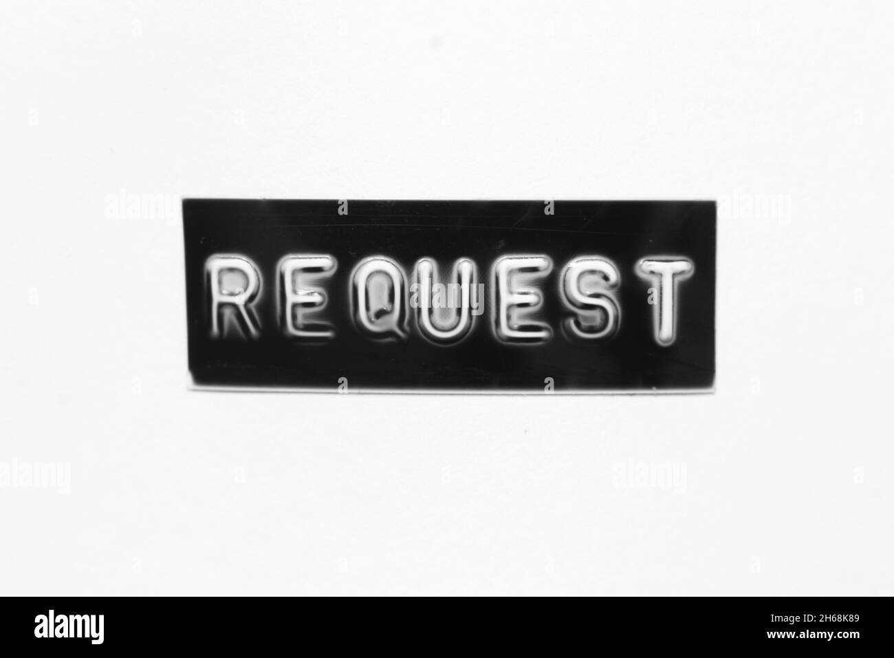 Black color banner that have embossed letter with word request on white ...