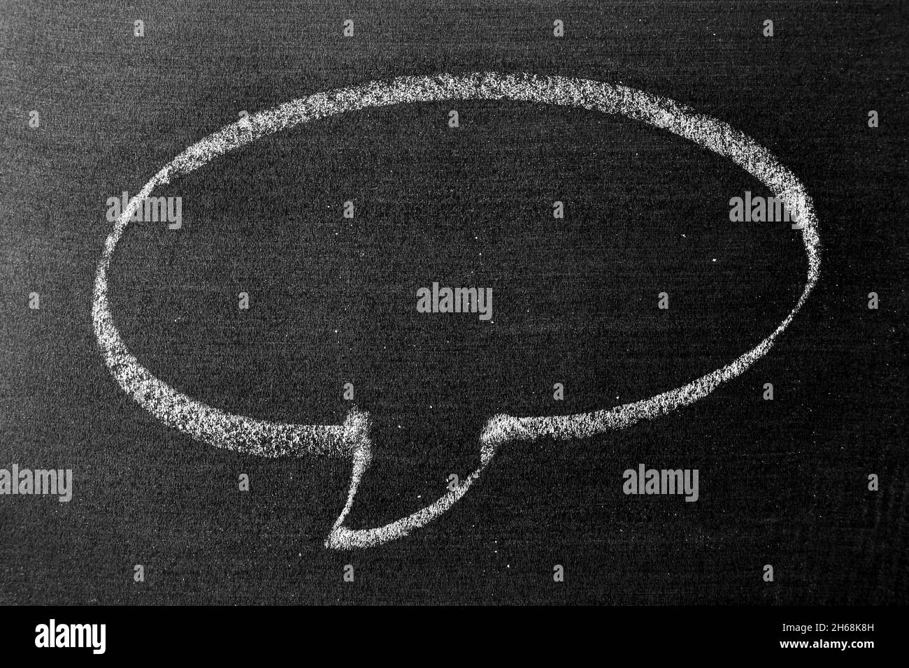 White color chalk hand drawing in round bubble speech shape with blank ...