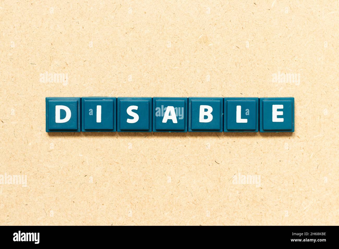 Tile alphabet letter in word disable on wood background Stock Photo - Alamy