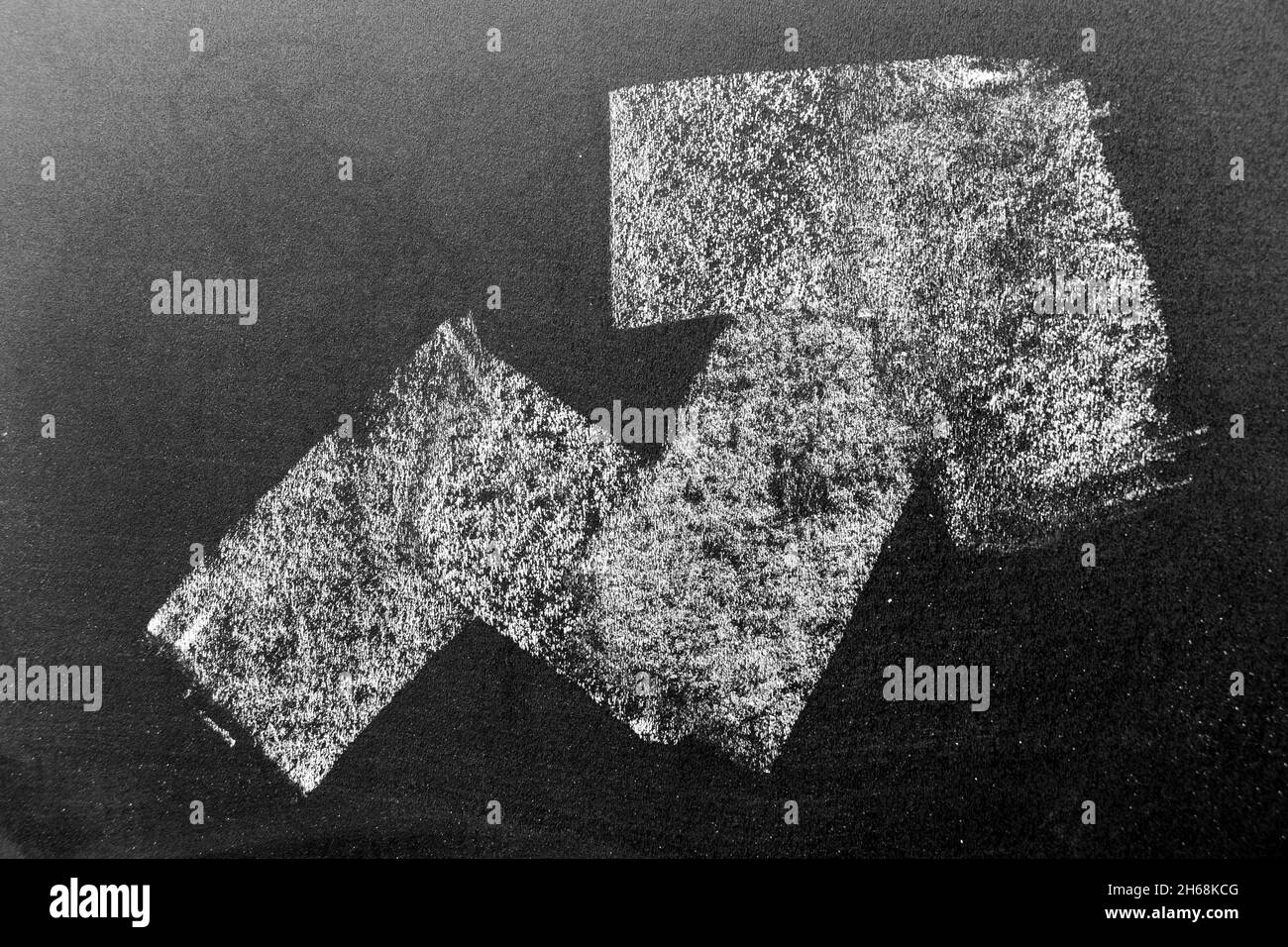 White color chalk hand drawing in shape on black board background ...