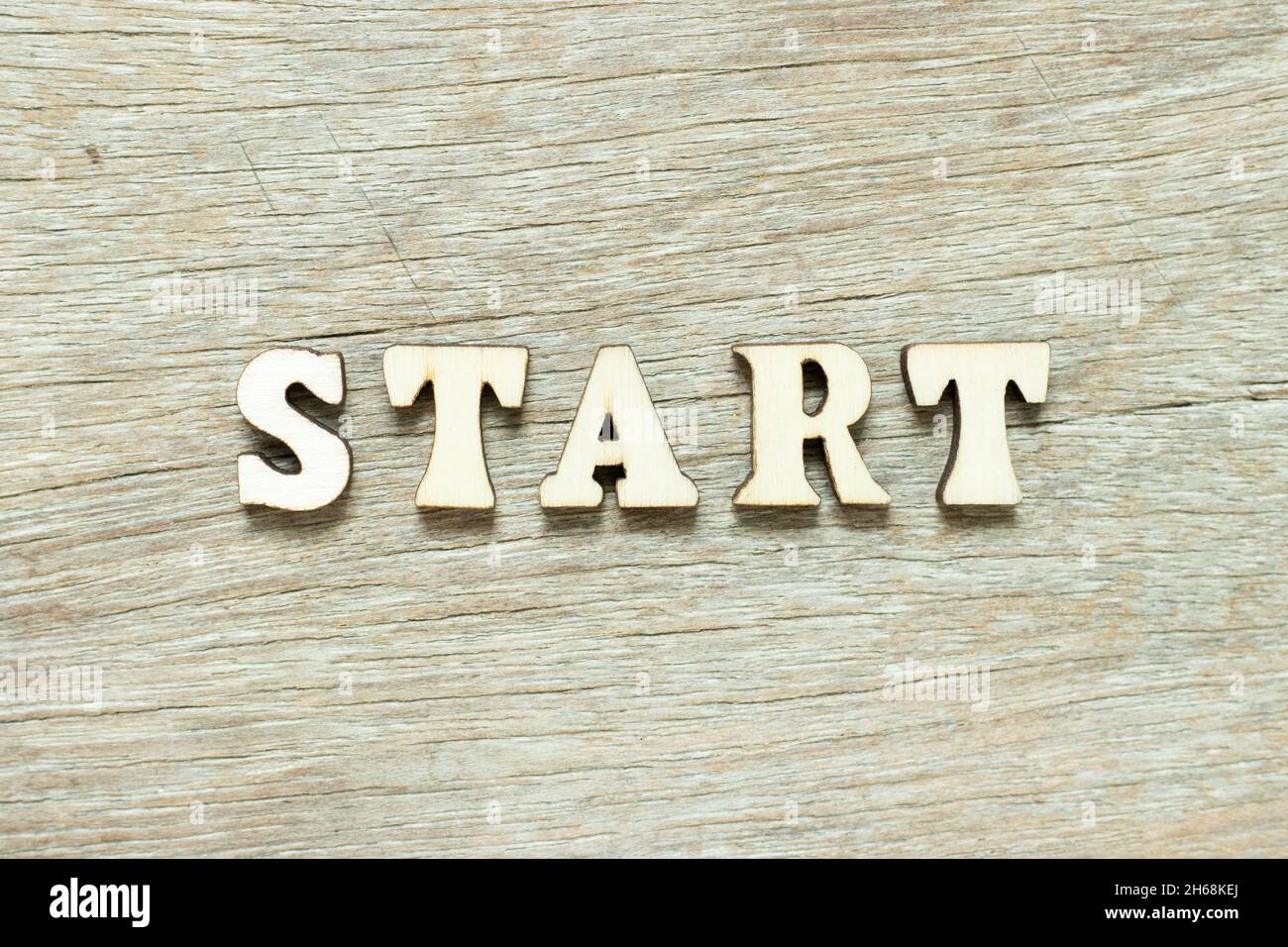 Alphabet letter in word start on wood background Stock Photo - Alamy