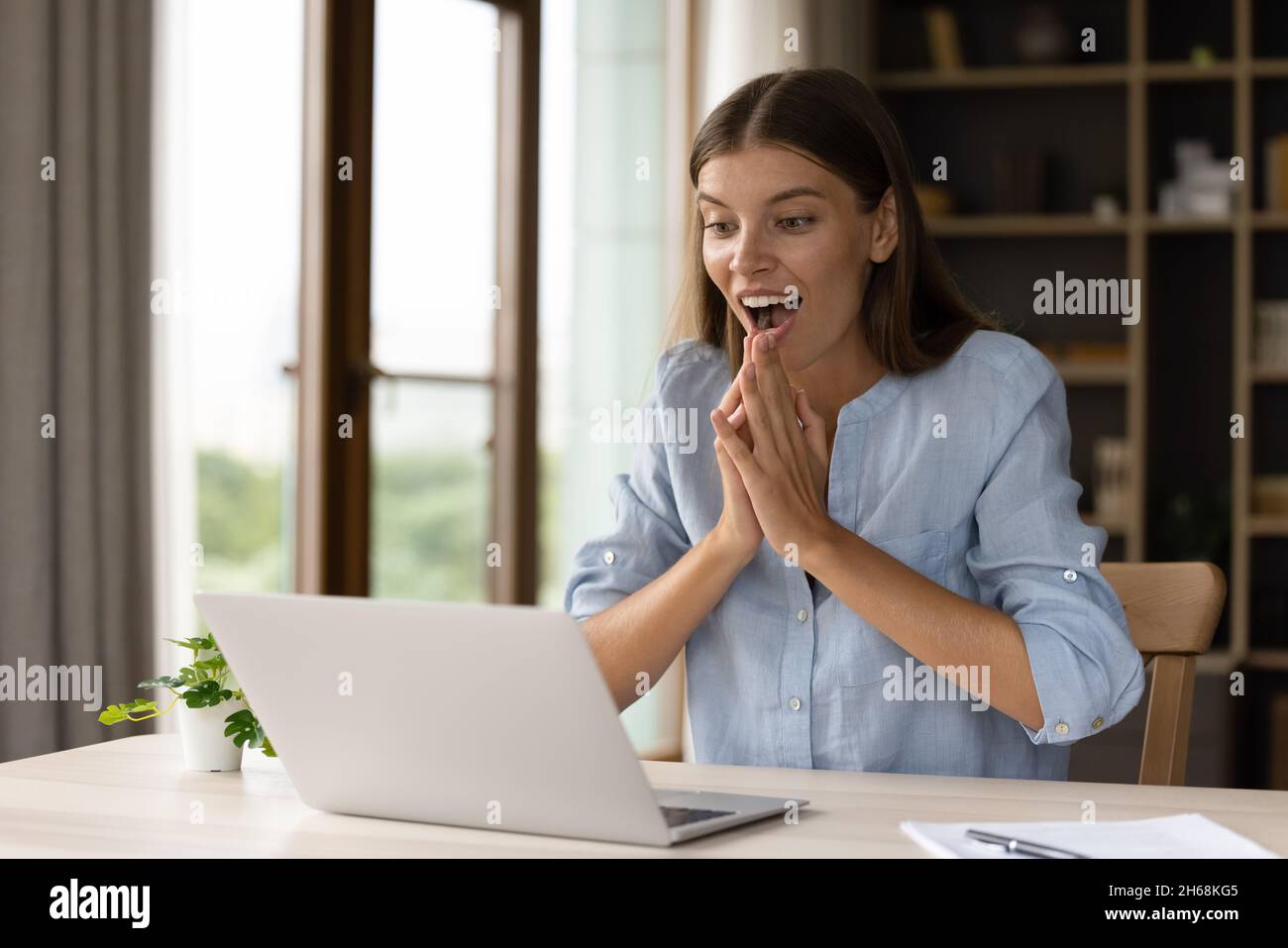Happy surprised young businesswoman looking at computer screen Stock ...