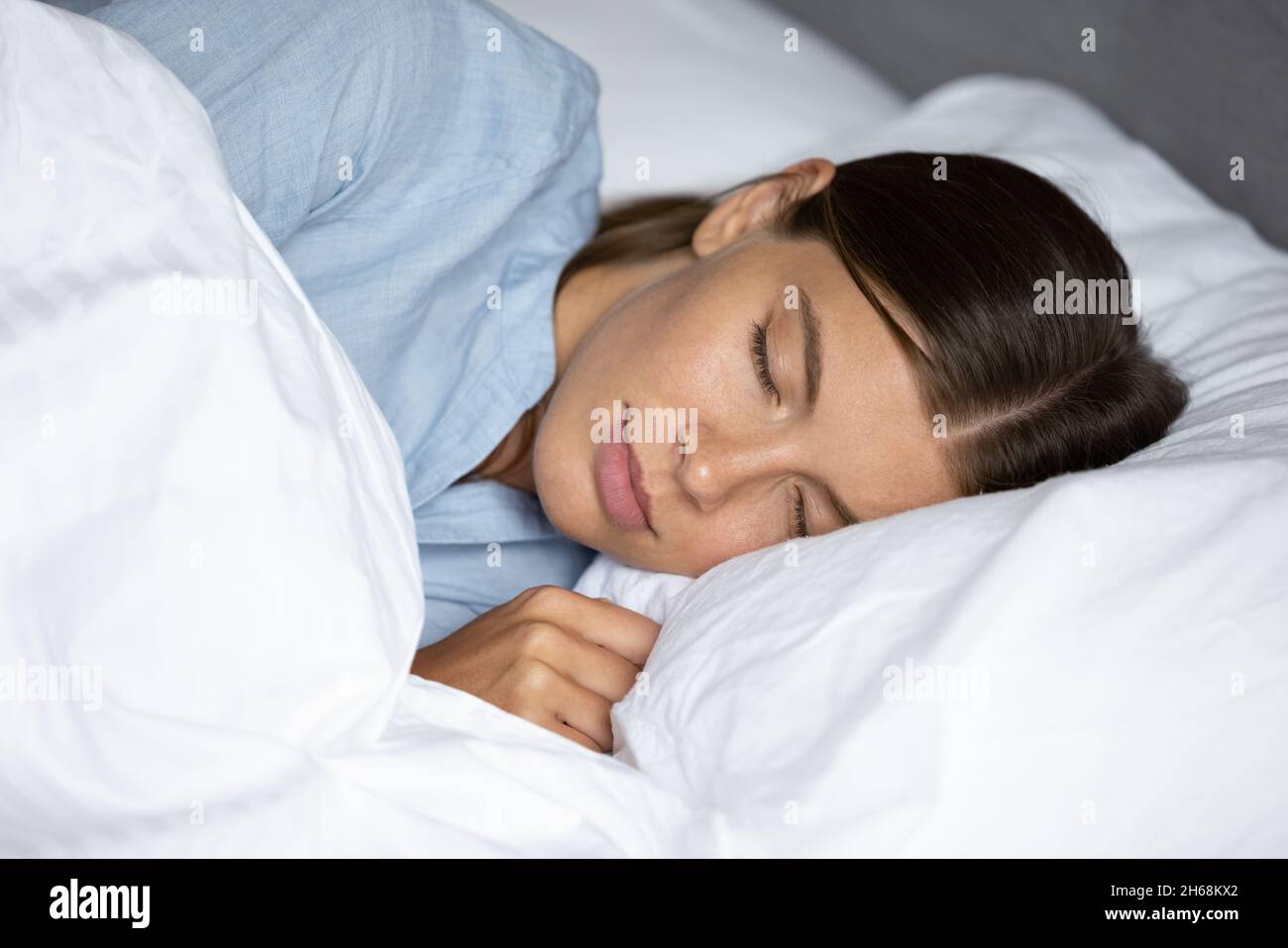 Pretty brunette sleeping in bed hi-res stock photography and images - Alamy