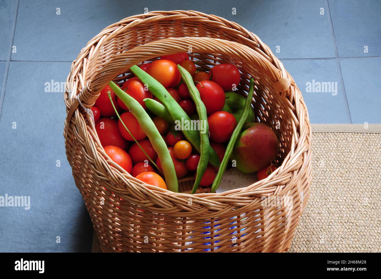 Basket of tomatoes, runner beans, apples Stock Photo - Alamy