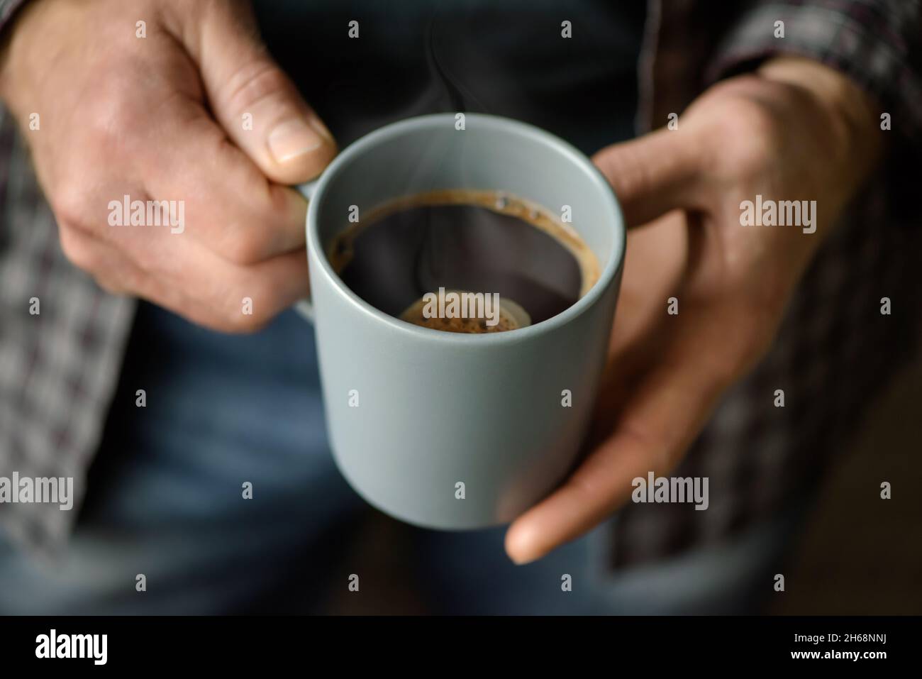 Cup of coffee in a man's hand Stock Photo - Alamy