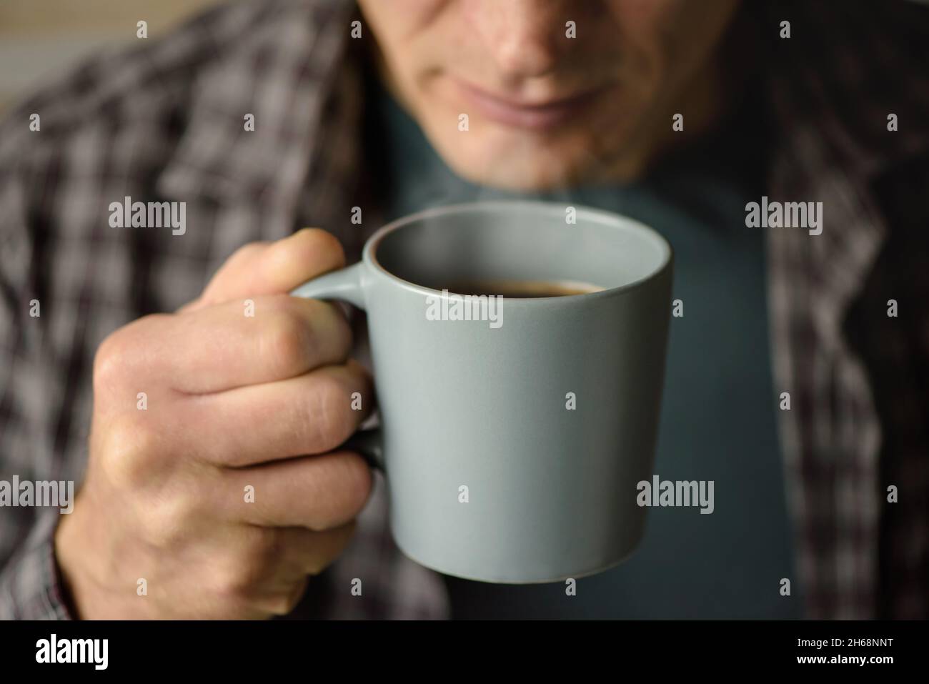 Cup of coffee in a man's hand Stock Photo - Alamy