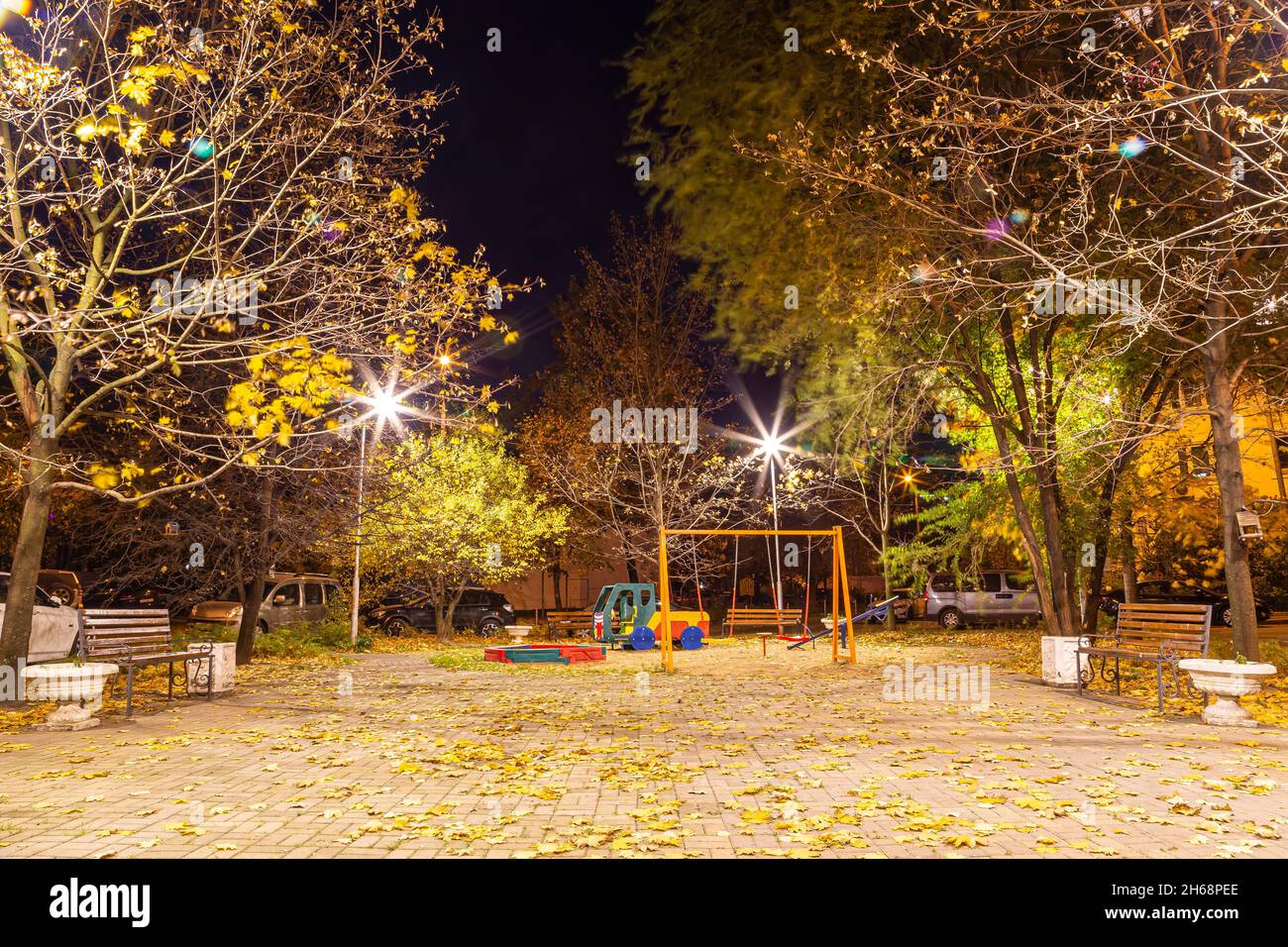 An empty playground on an autumn night in one of the residential areas ...