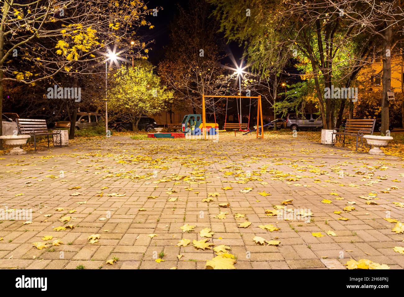 An empty playground on an autumn night in one of the residential areas ...