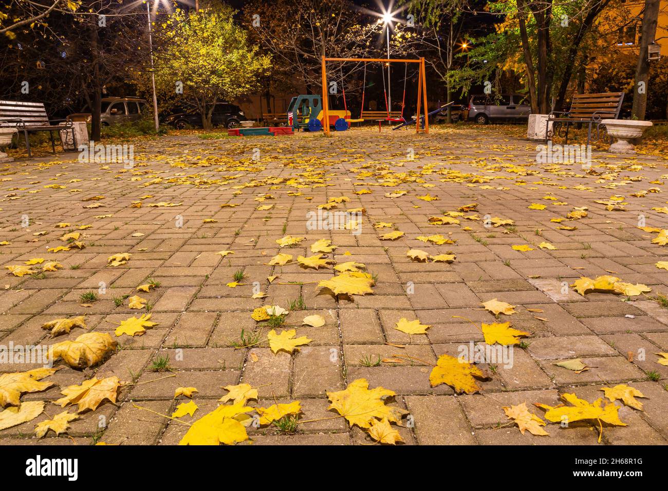 An empty playground on an autumn night in one of the residential areas ...
