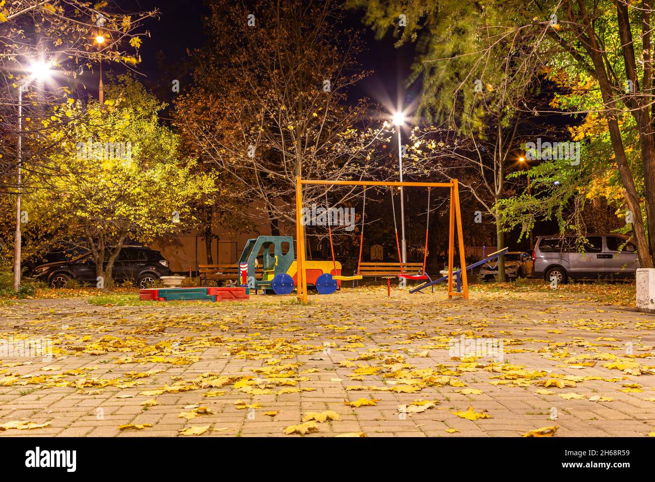 An empty playground on an autumn night in one of the residential areas ...