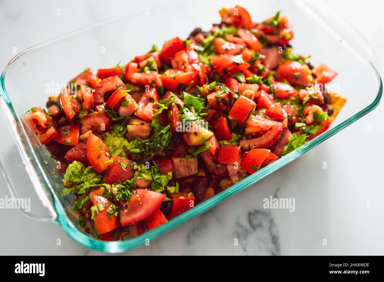 vegan nachos with corn chips bean mix guacamole and fresh tomato salsa ...