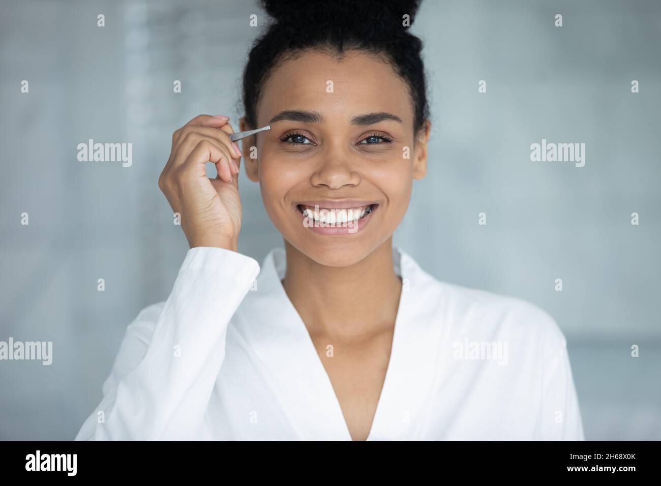 Beautiful young african ethnicity woman styling eyebrows Stock Photo ...