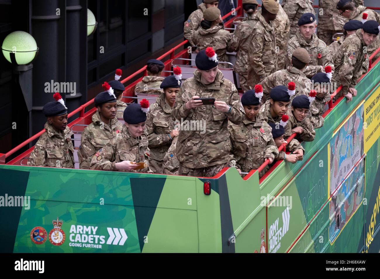 Army cadet teenagers enjoy the top deck of a recuiting bus before the ...