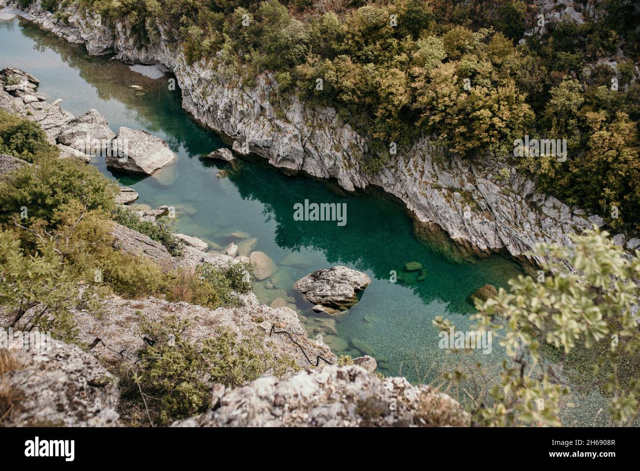 An aerial view of a river between cliffs covered in trees Stock Photo ...