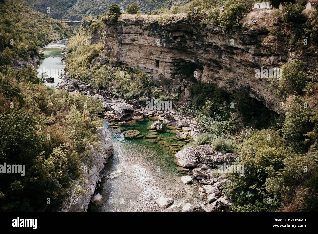 A river between cliffs covered in trees in a mountainous area Stock ...