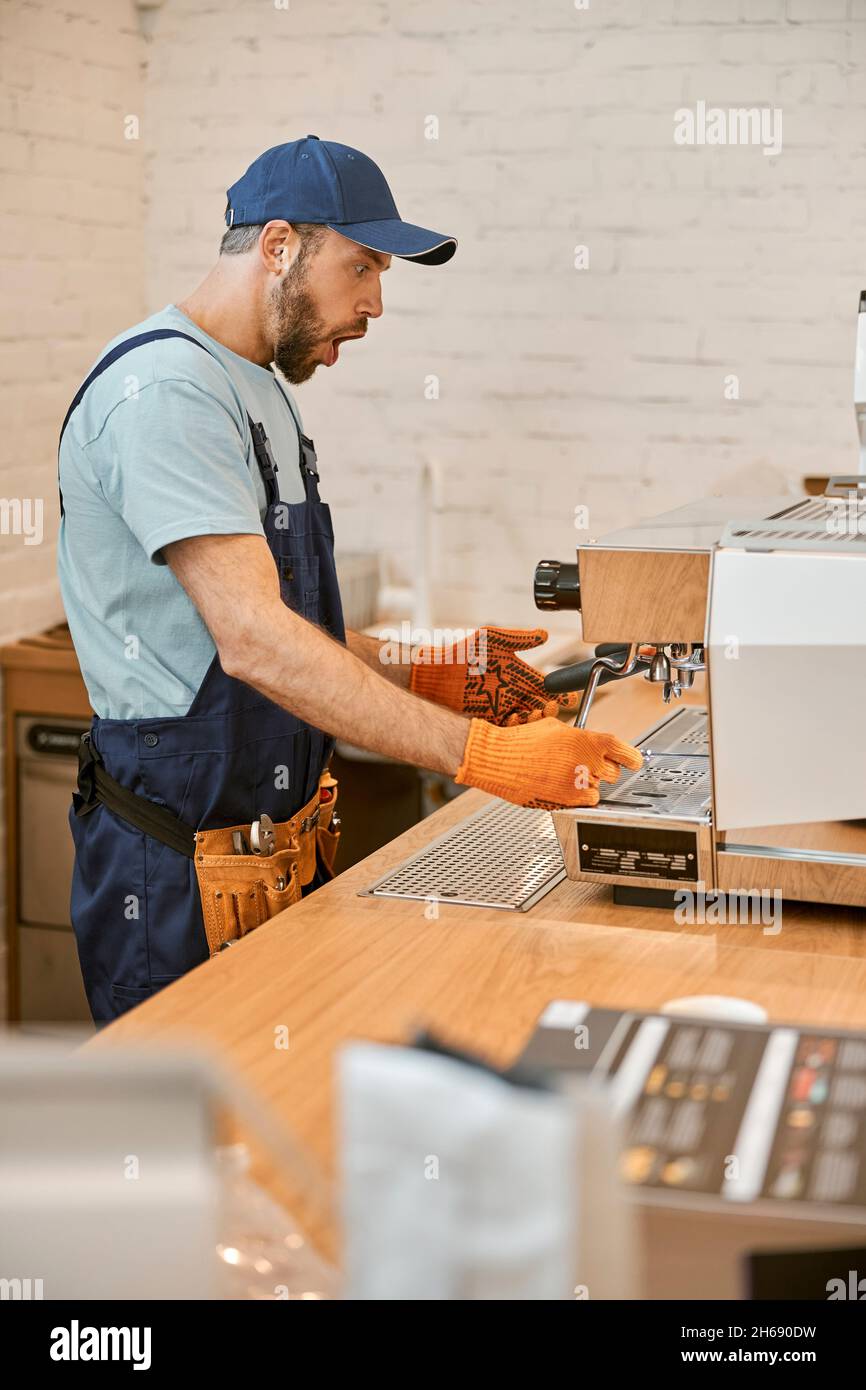 Repairman fixing coffee machine hi-res stock photography and images - Alamy