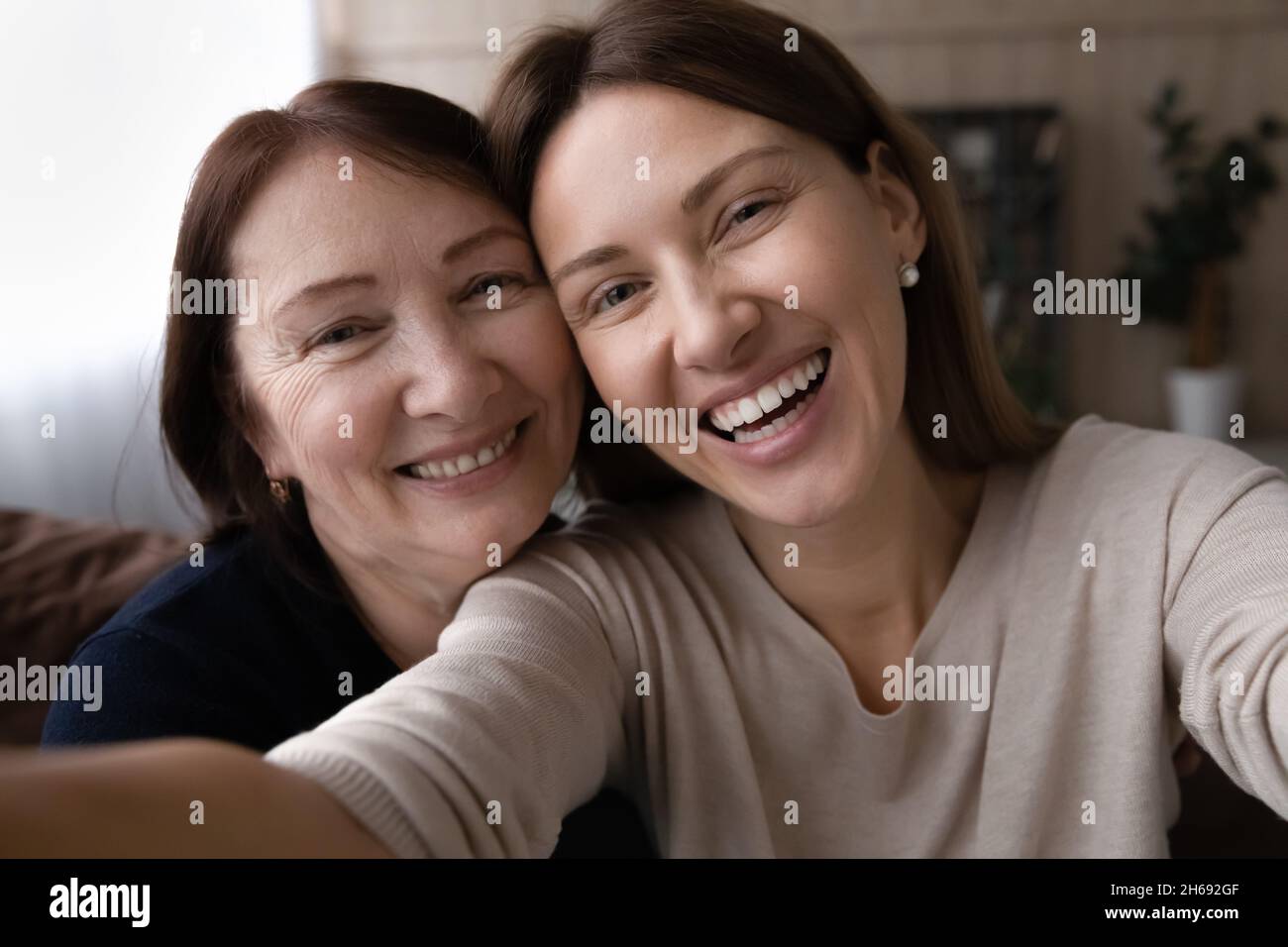 Head shot portrait happy woman with mature mother taking selfie Stock ... Head shot portrait happy woman with mature mother taking selfie Stock ...