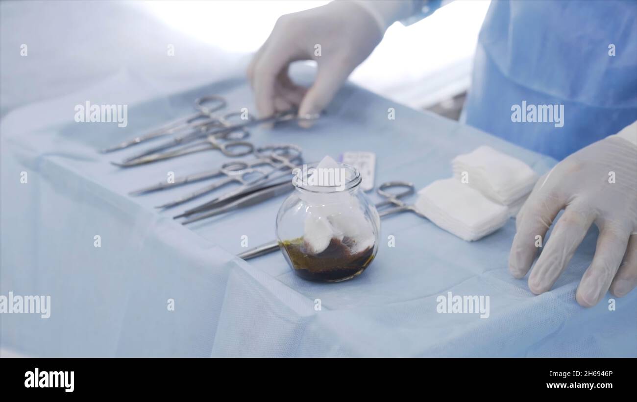 Close-up of surgeon preparing instruments for surgery. Action ...
