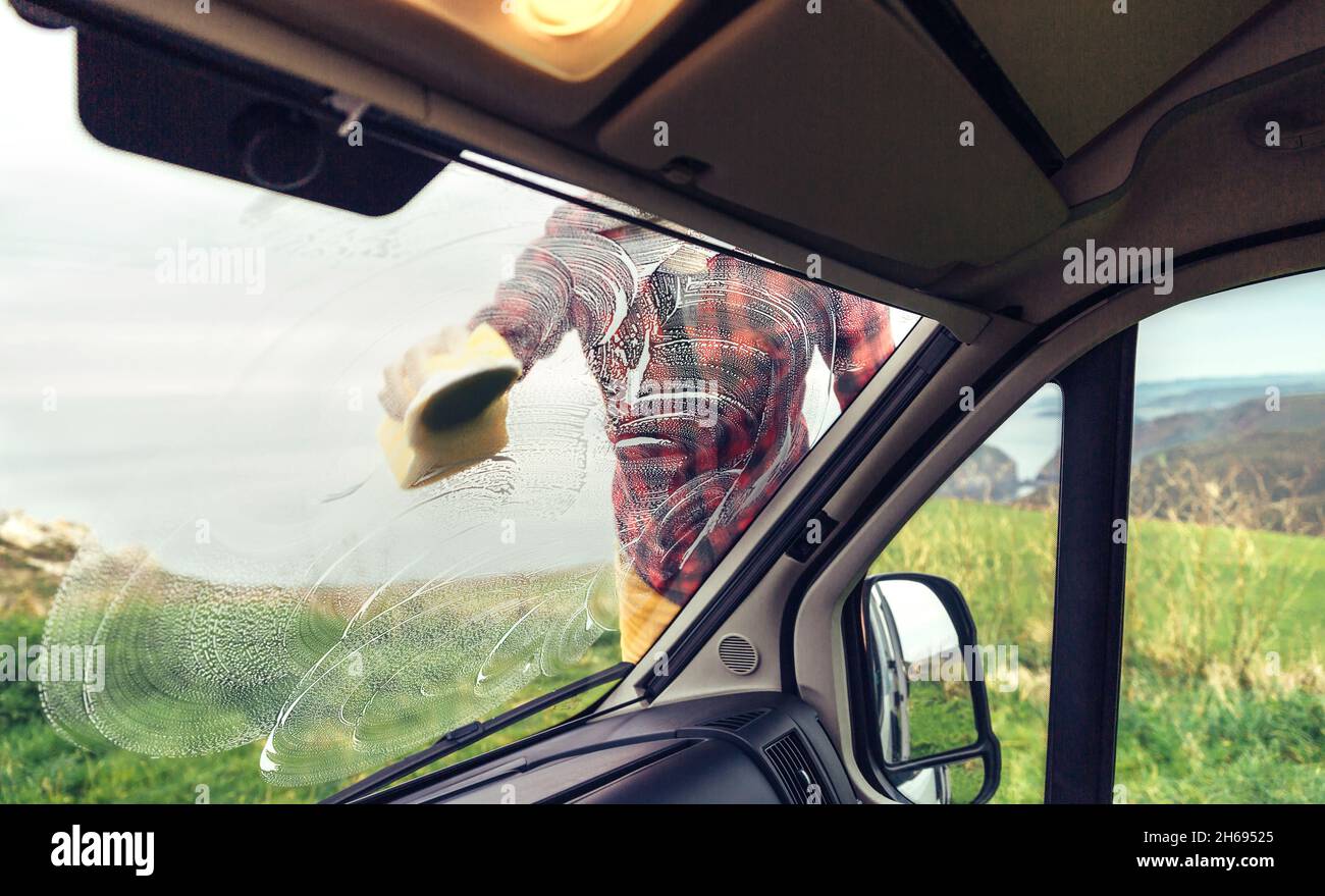 Man cleaning camper van windshield outdoor Stock Photo - Alamy