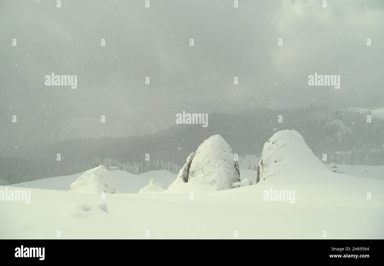 Snowed on rocks in a snow storm Stock Photo - Alamy