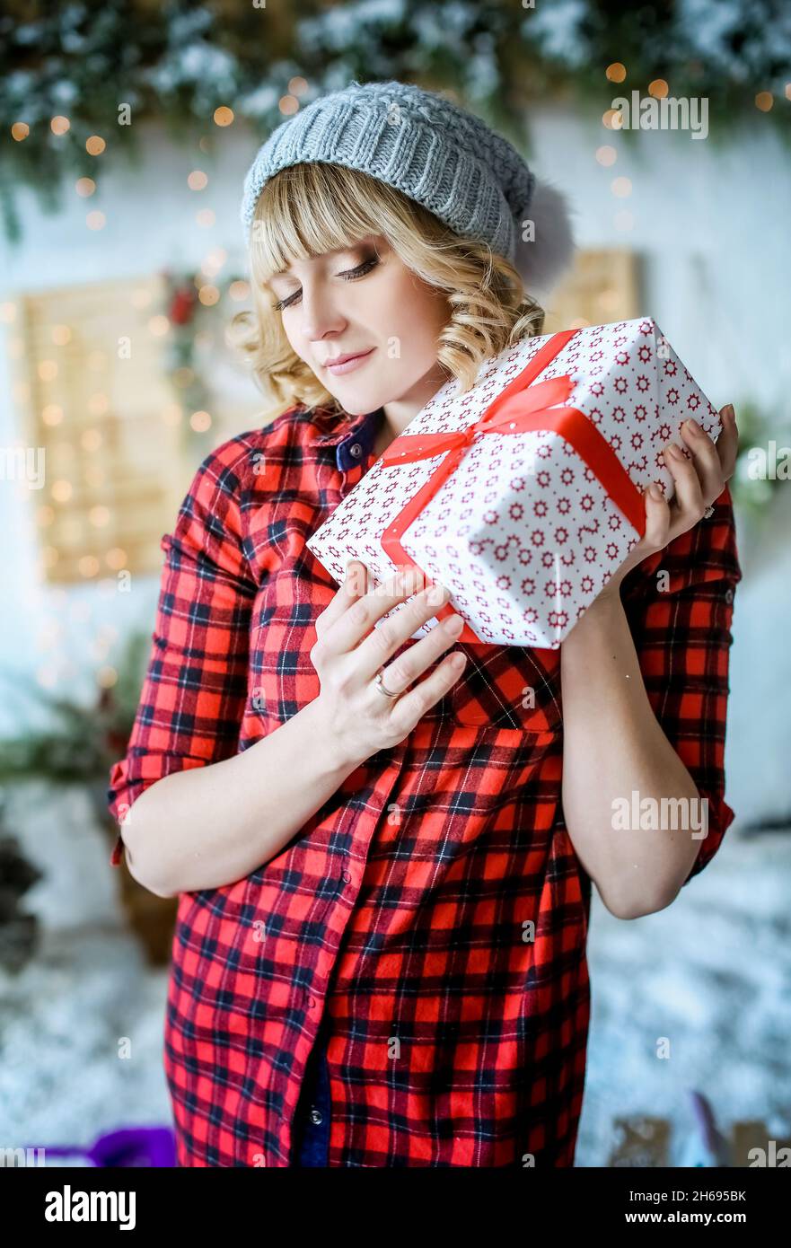 Girl smiles and holds white box with red ribbon in the hands of Stock ...