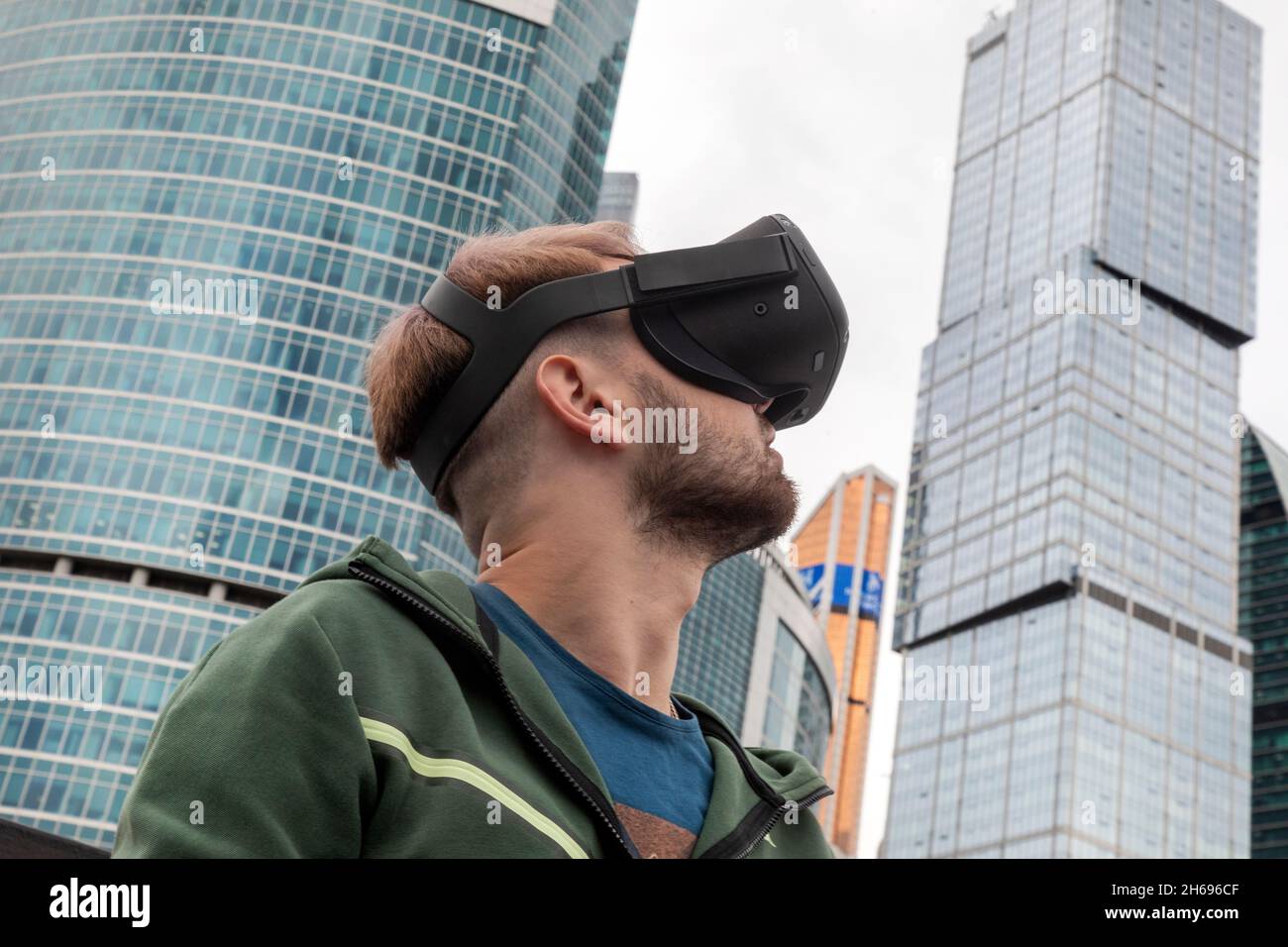 Moscow, Russia. 21st of August, 2021 A young man wearing virtual ...