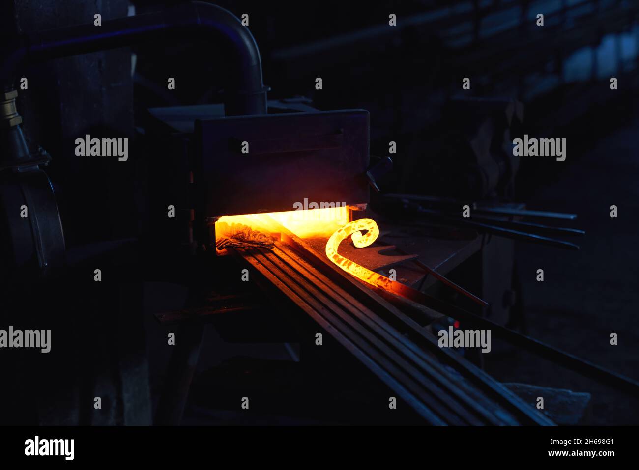 Close up of forge furnace with pieces of steel heating inside ...