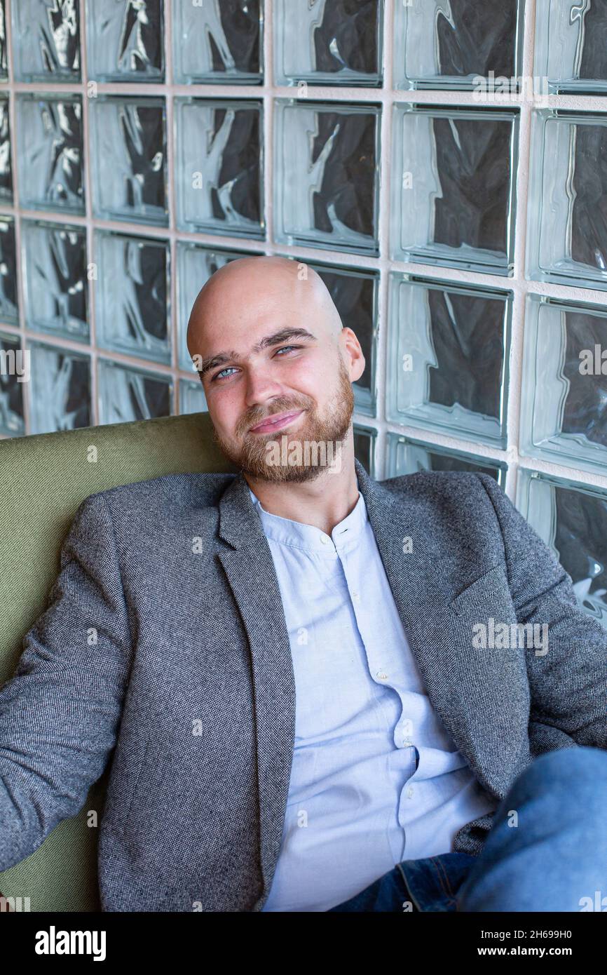 Portrait of white european bald man with beard and grey eyes in suit ...