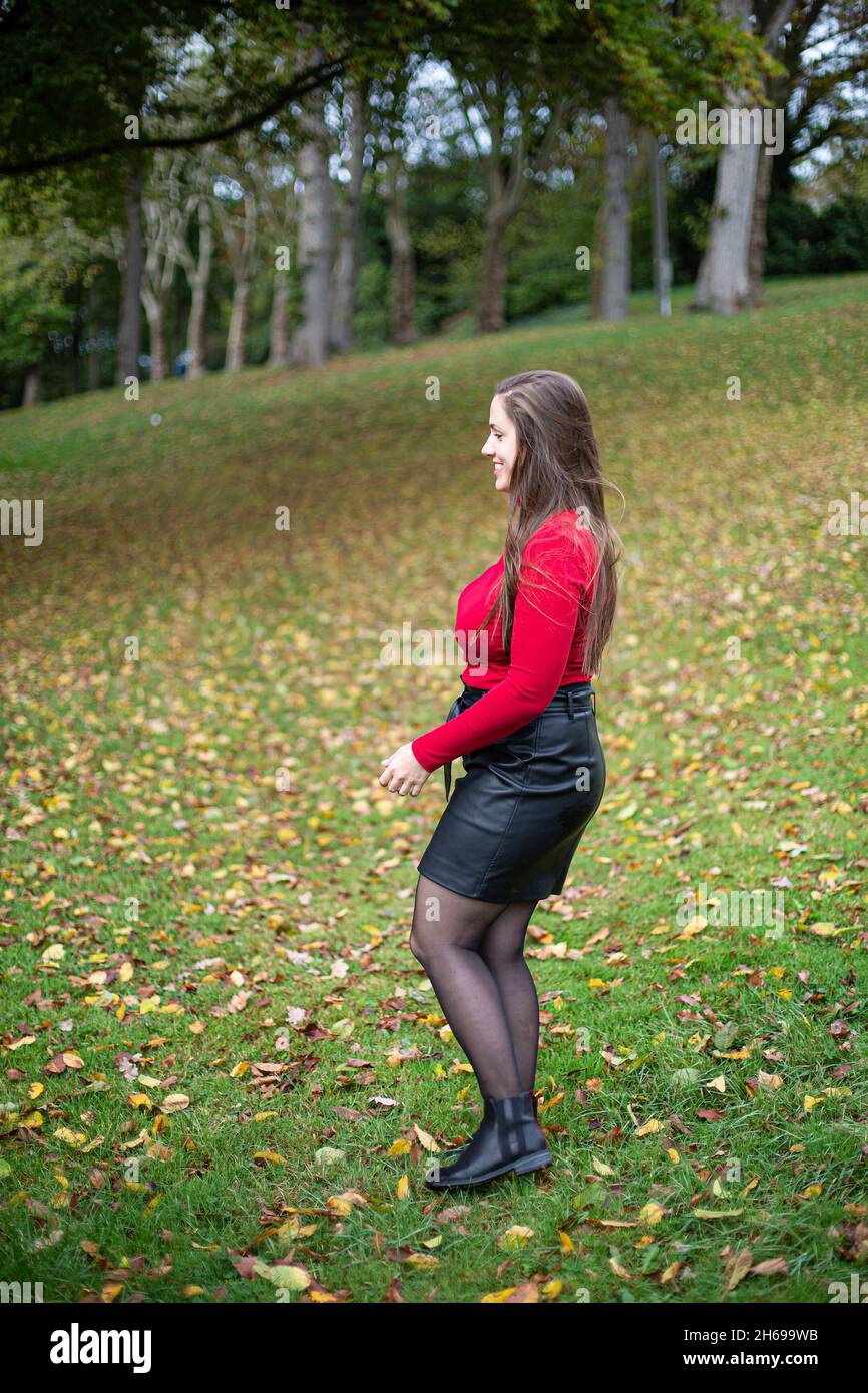 White young european woman in red in autumn park Stock Photo - Alamy
