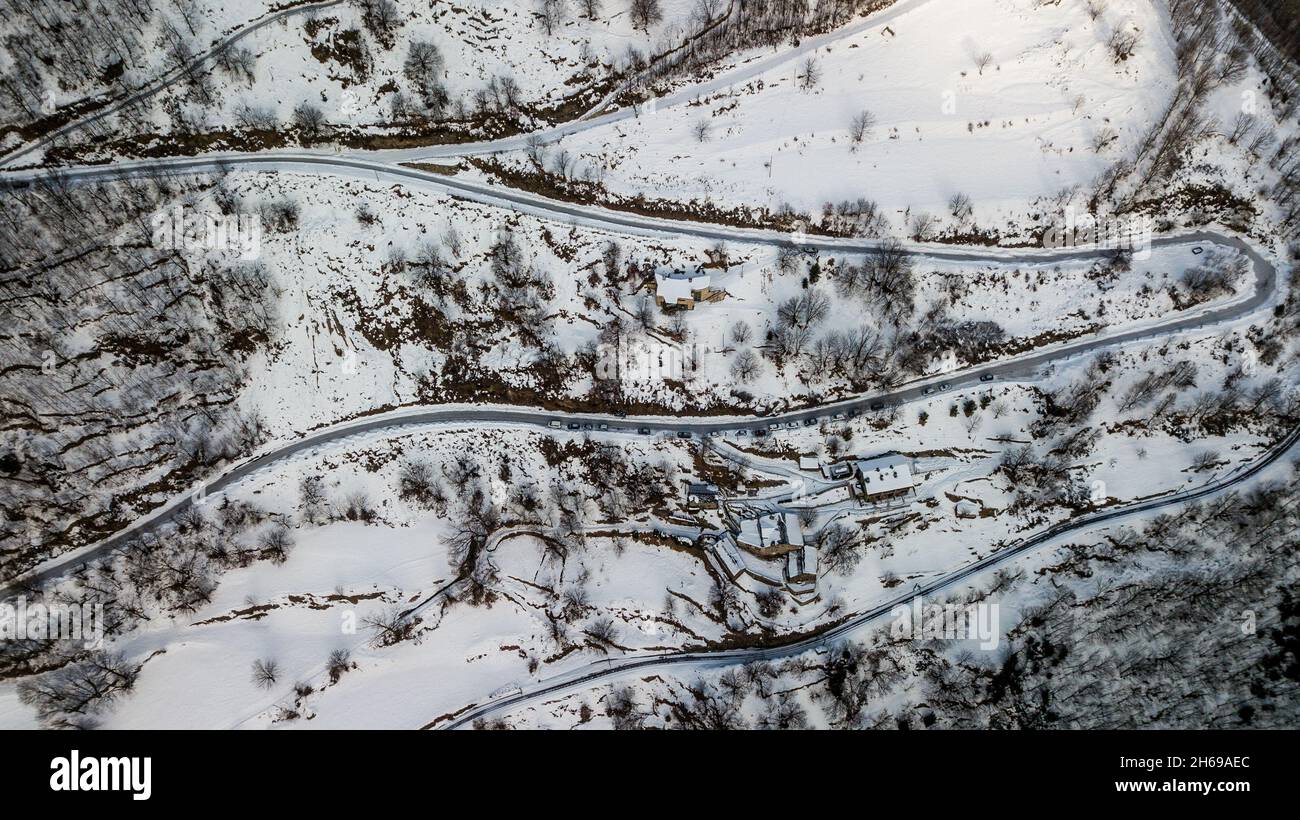 An aerial view of a winding road in the snowy mountains Stock Photo - Alamy