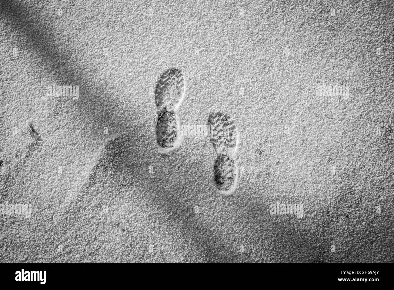 Two footsteps on the snow surface Stock Photo - Alamy