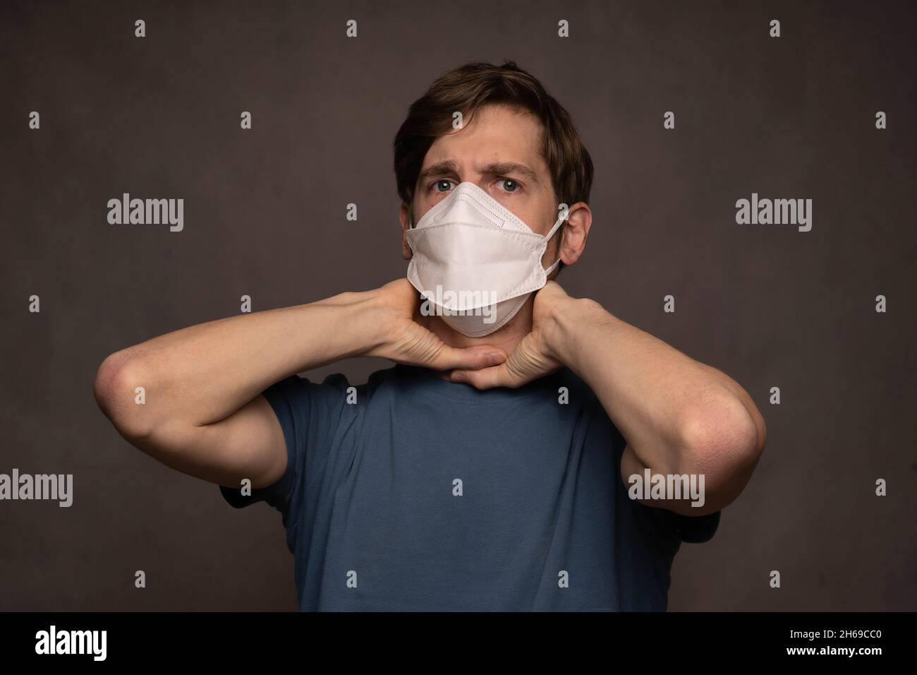 Young handsome tall slim white man with brown hair choking himself ...