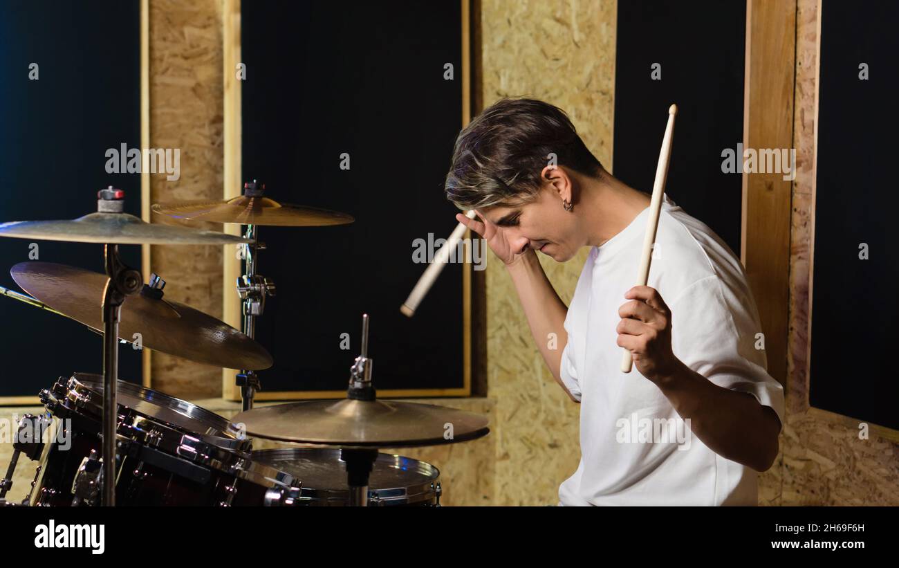 Musician artist beating rhythm is rehearsing behind drum kit in ...