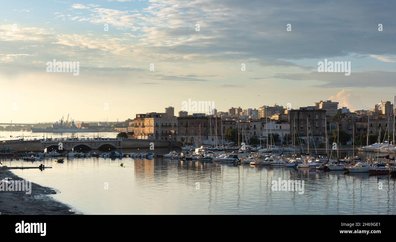 Sea port. Ships and boats at dawn. Sea town. Taranto Stock Photo - Alamy