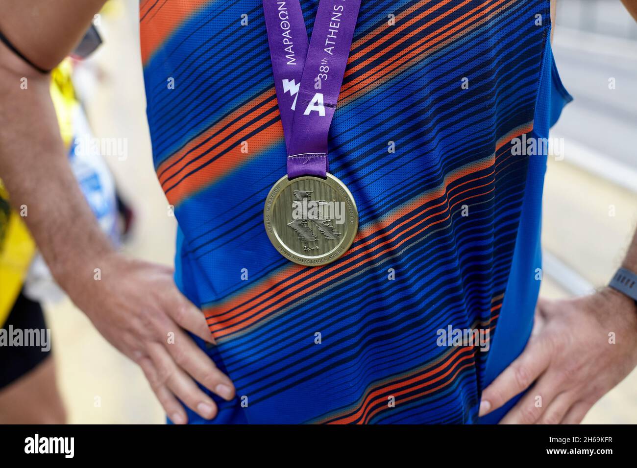 Athlete wearing Athens marathon medal Stock Photo - Alamy