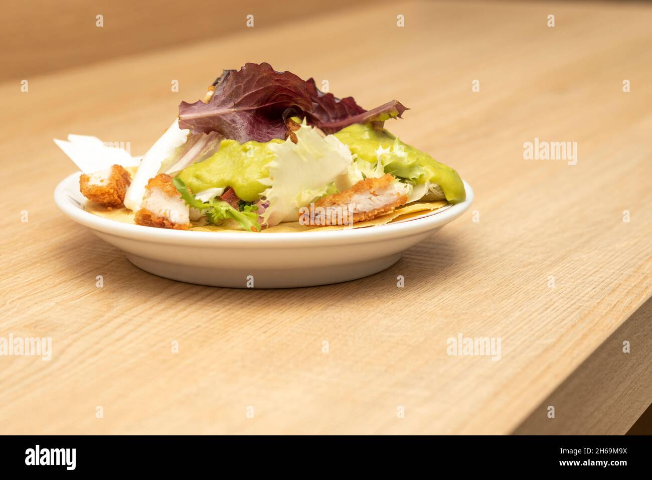 Mexican mariachi taco with fried battered chicken with guacamole sauce ...