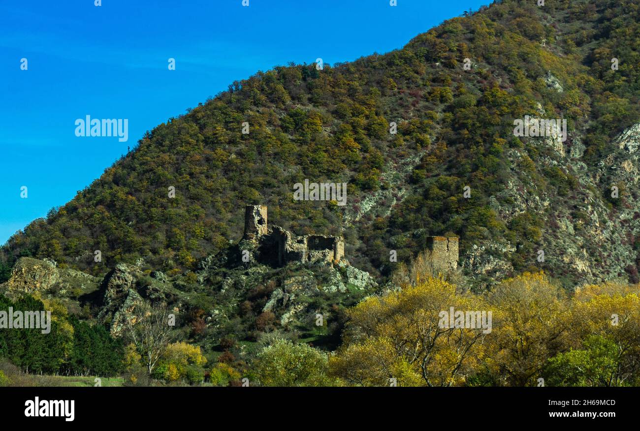 Ruins of medieval castle on the hilltop of Caucasus mountains in ...
