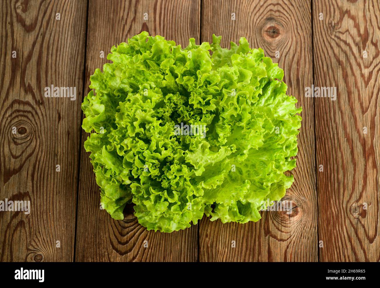 Lettuce bunch on a wood background Stock Photo - Alamy