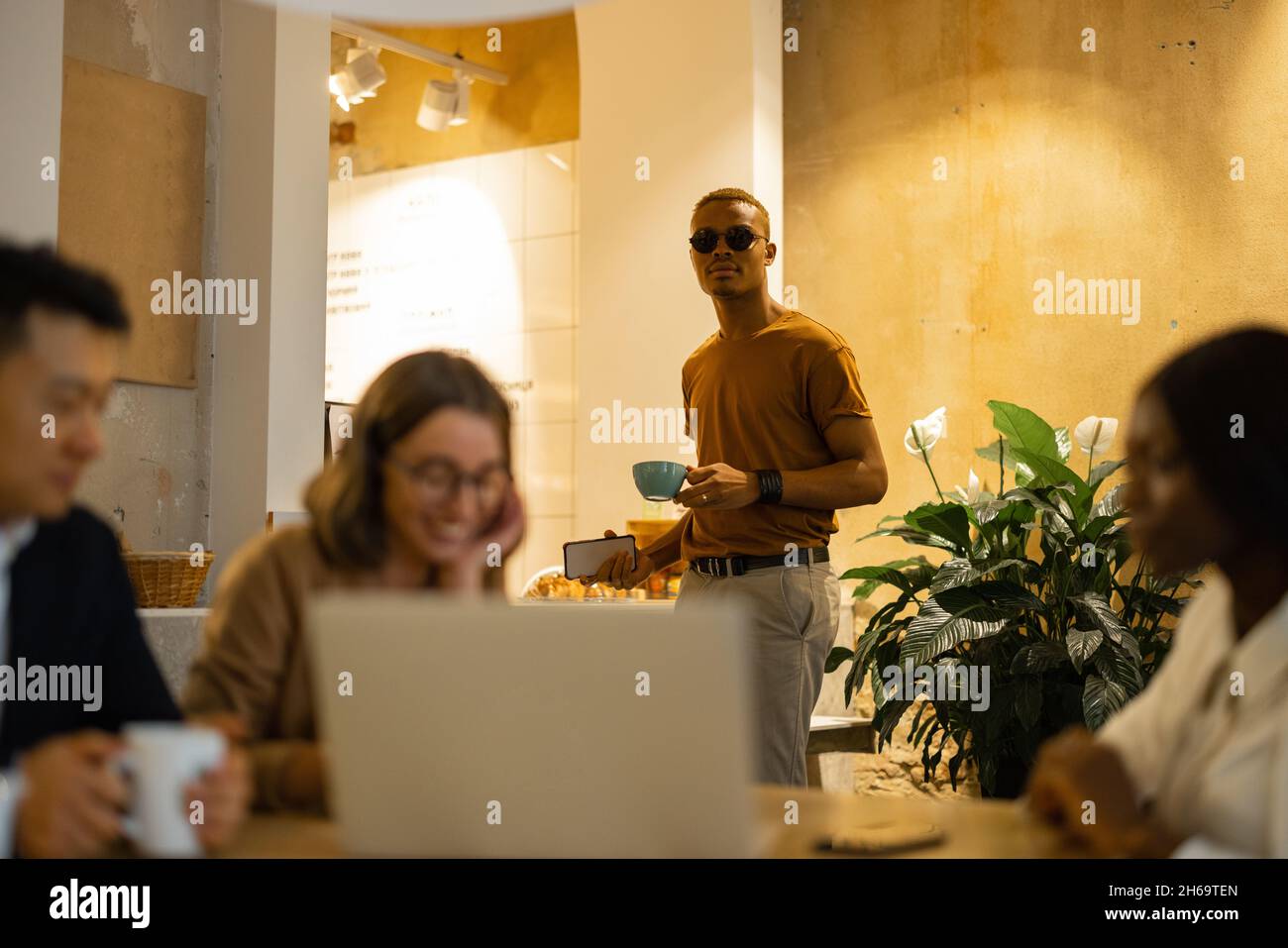Business team watching something on laptop in cafe Stock Photo - Alamy