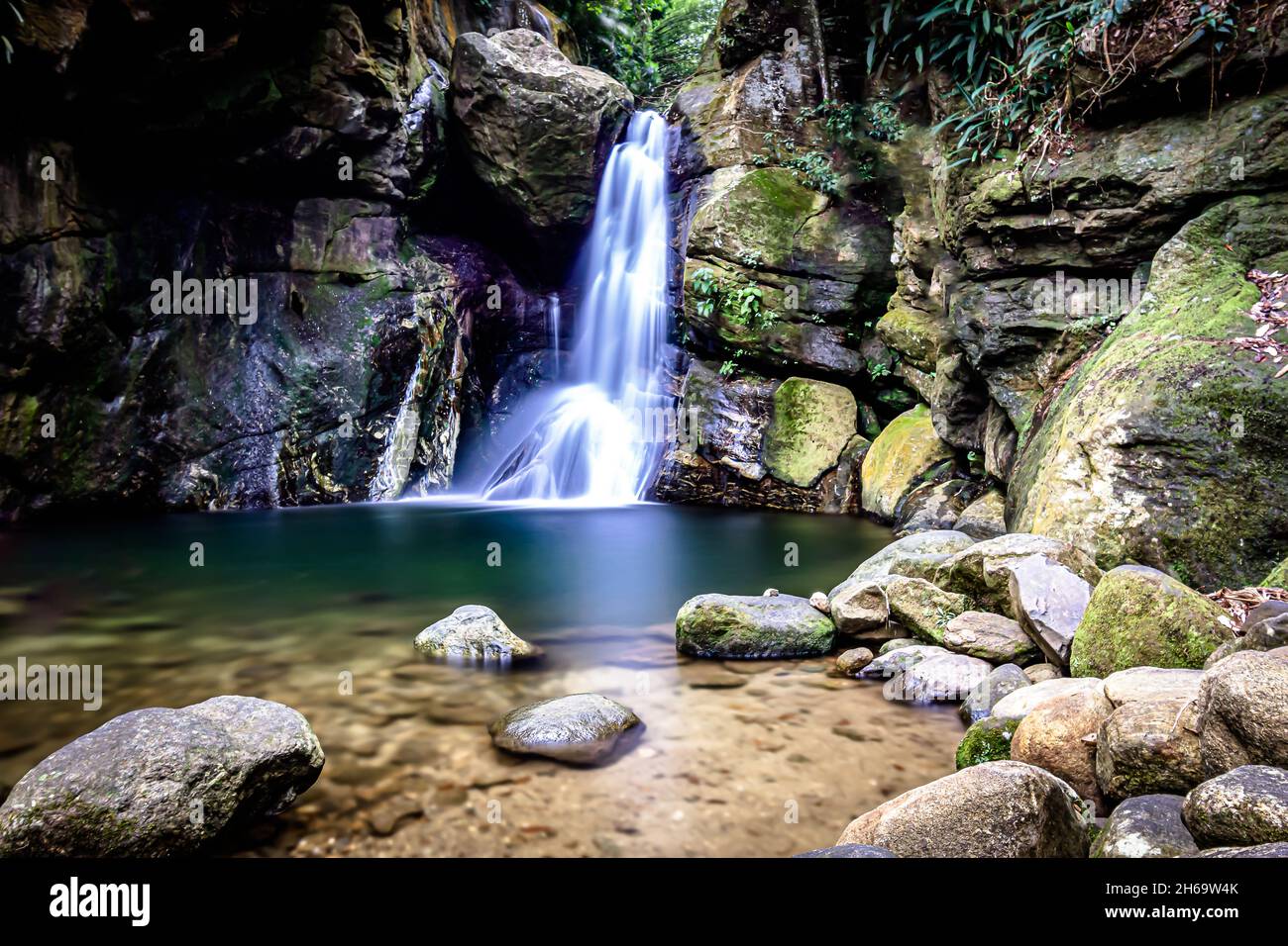 Beautiful landscape of a waterfall, with clear water, sliding between ...
