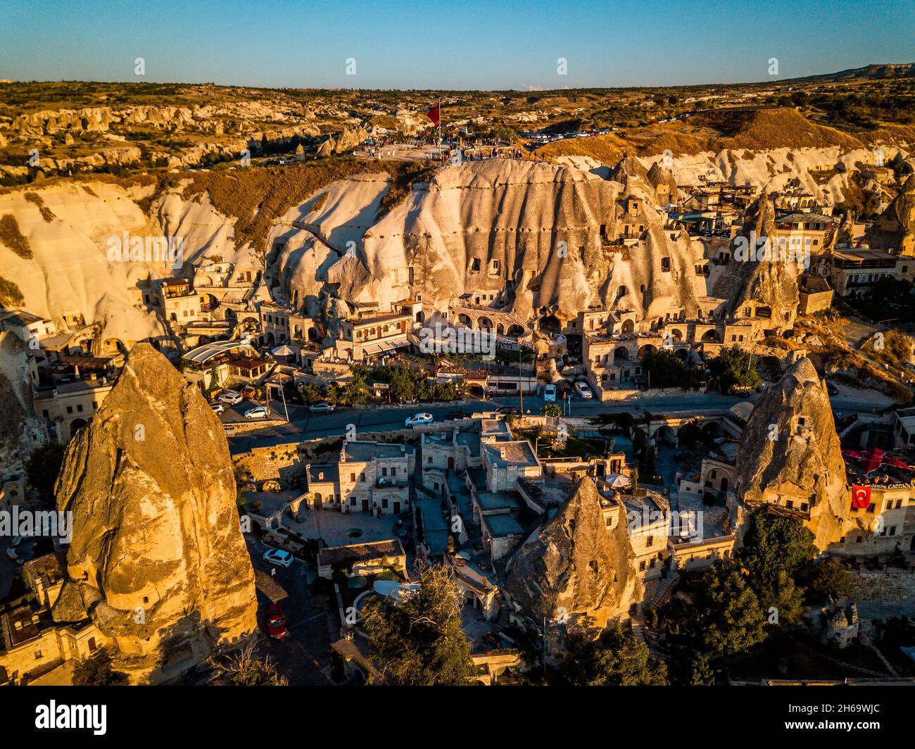 A landscape of rocky formations and buildings in Goreme, Cappadocia ...