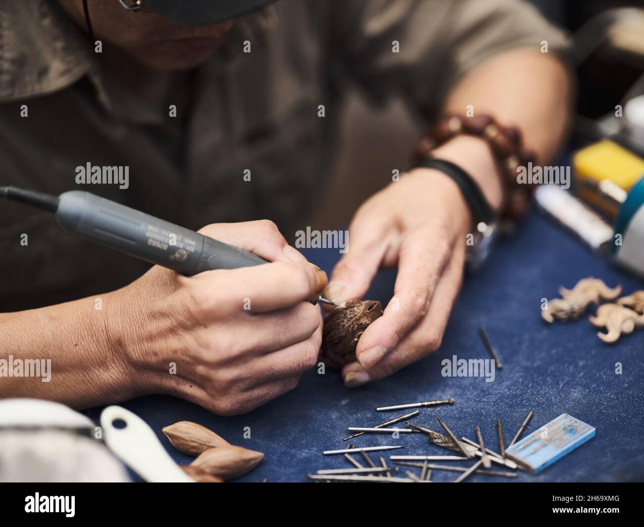 Senior hands carving nut shell Stock Photo - Alamy