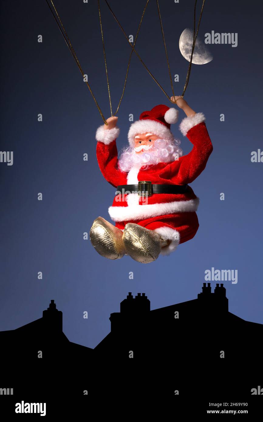 Father christmas in night sky with moon hi-res stock photography and ...