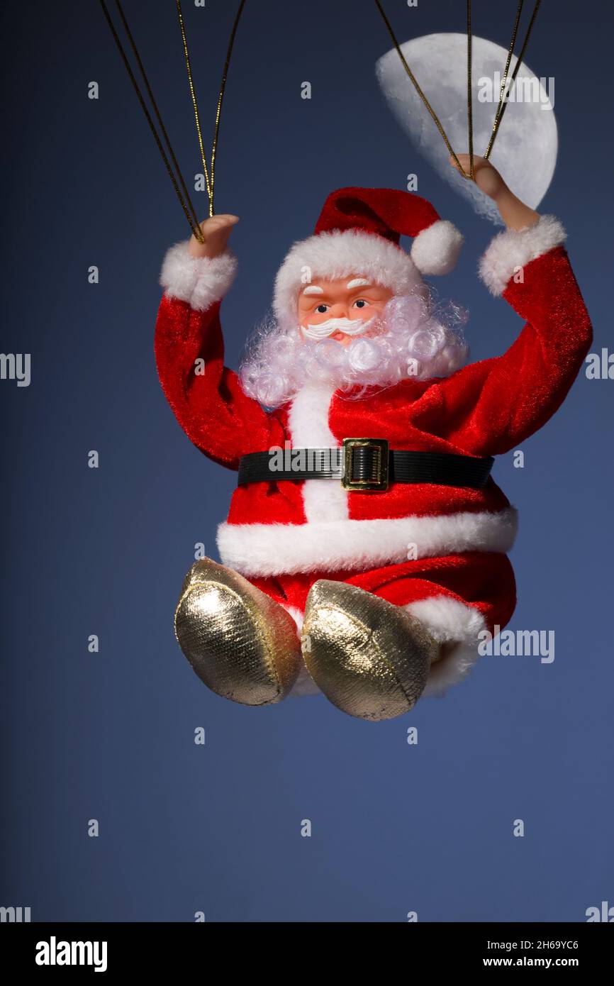 Santa Claus Father Christmas Parachuting in Night Sky with Moon Stock ...