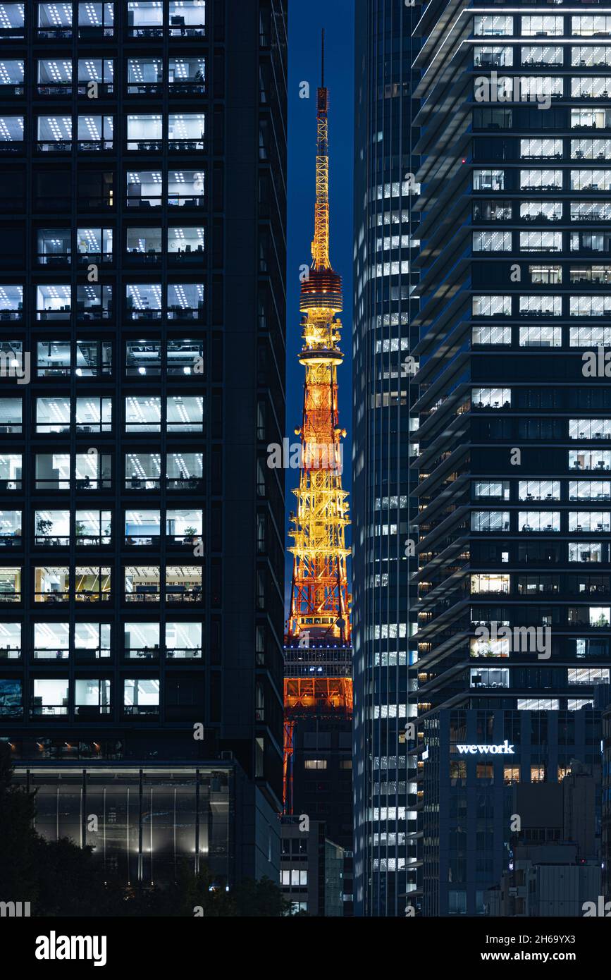 Tokyo Tower is visible between high rise buildings in Kasumigaseki ...