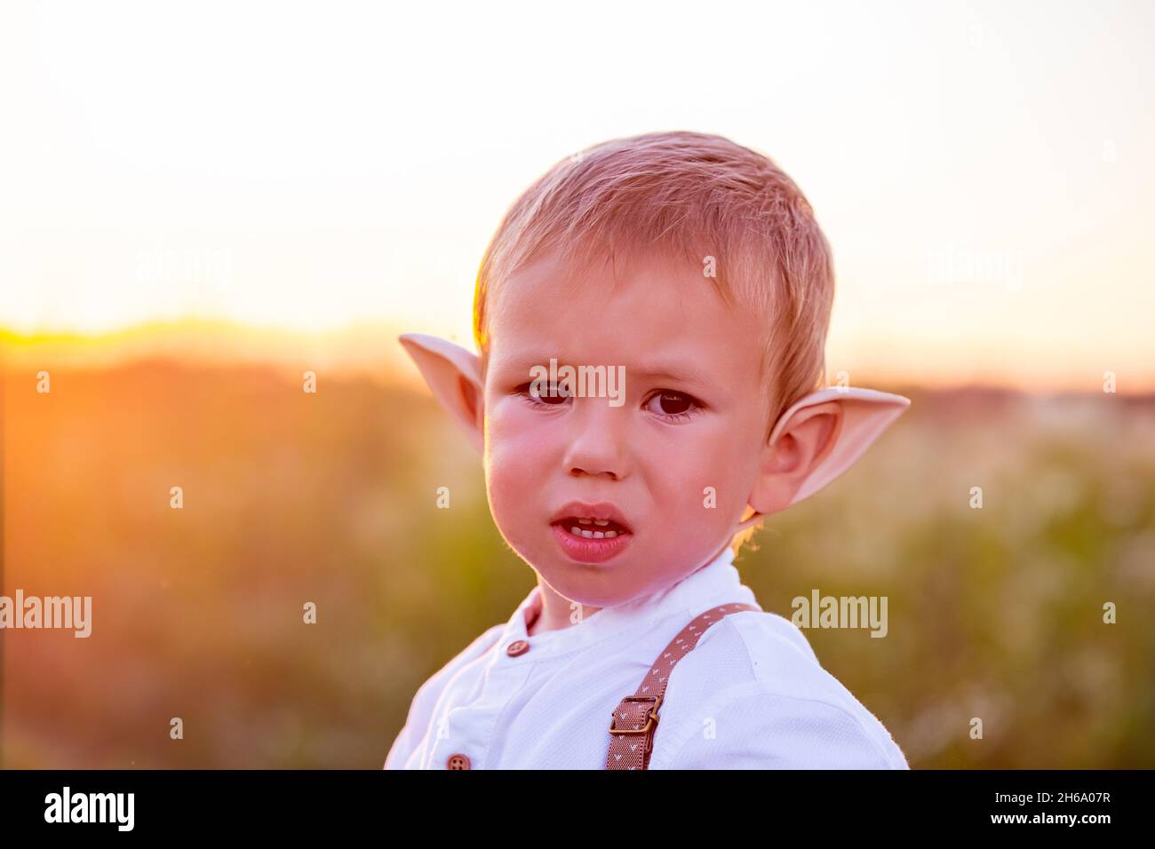 Portrait of crying little caucasian boy in a fairytale costume of elf ...