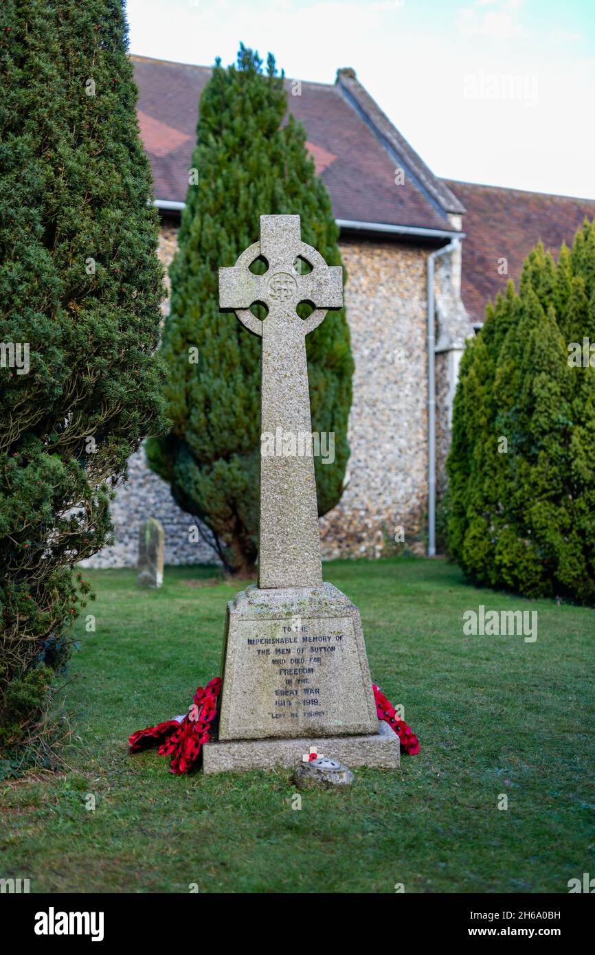 Red poppy wreaths laid on a war memorial in remembrance of war dead ...